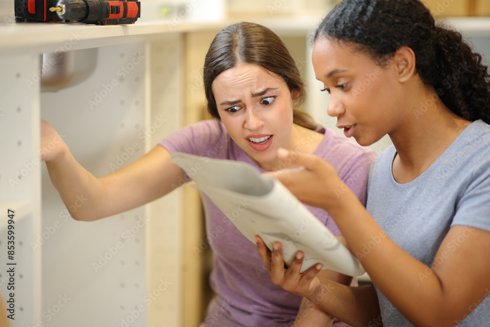 Frustrated roommates arguing checking installation manual Stock Photo ...