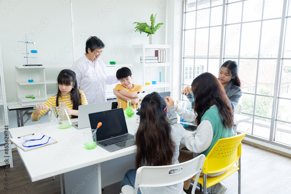 Group of students in science lab performing experiments with beakers ...