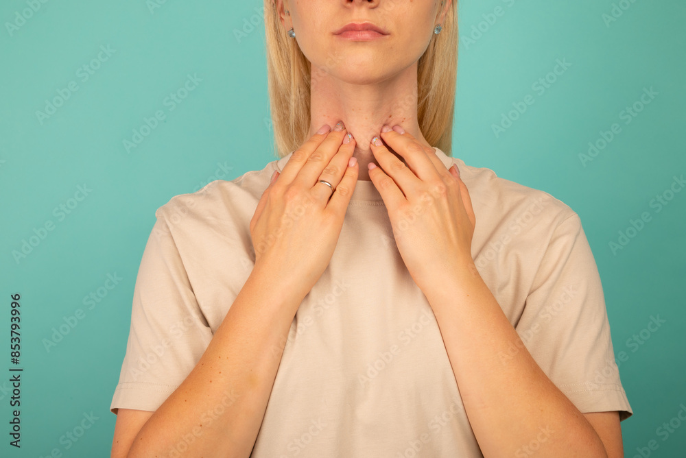 Female checking thyroid gland by herself. Thyroid disorder includes ...