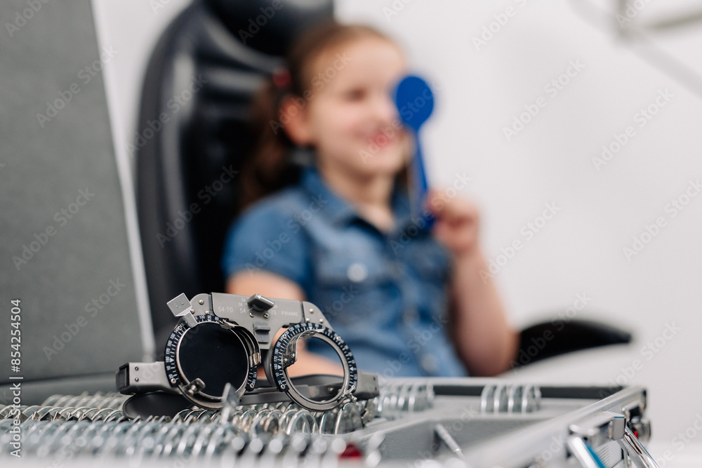 Cute baby testing visual acuity with one eye closed. Concept of ...