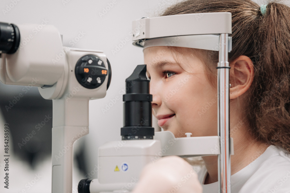 Examination of the child using a slit lamp. Microscope and focused ...