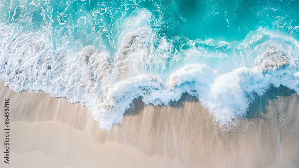 blue ocean waves washing up on a sun-kissed beach, captured from a ...
