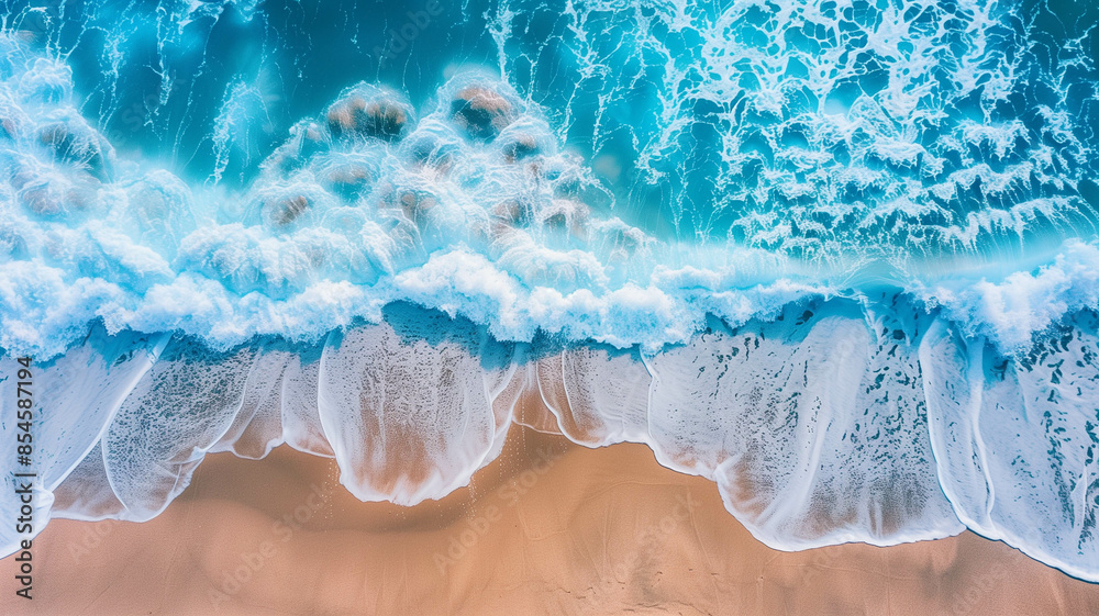 blue ocean waves washing up on a sun-kissed beach, captured from a ...
