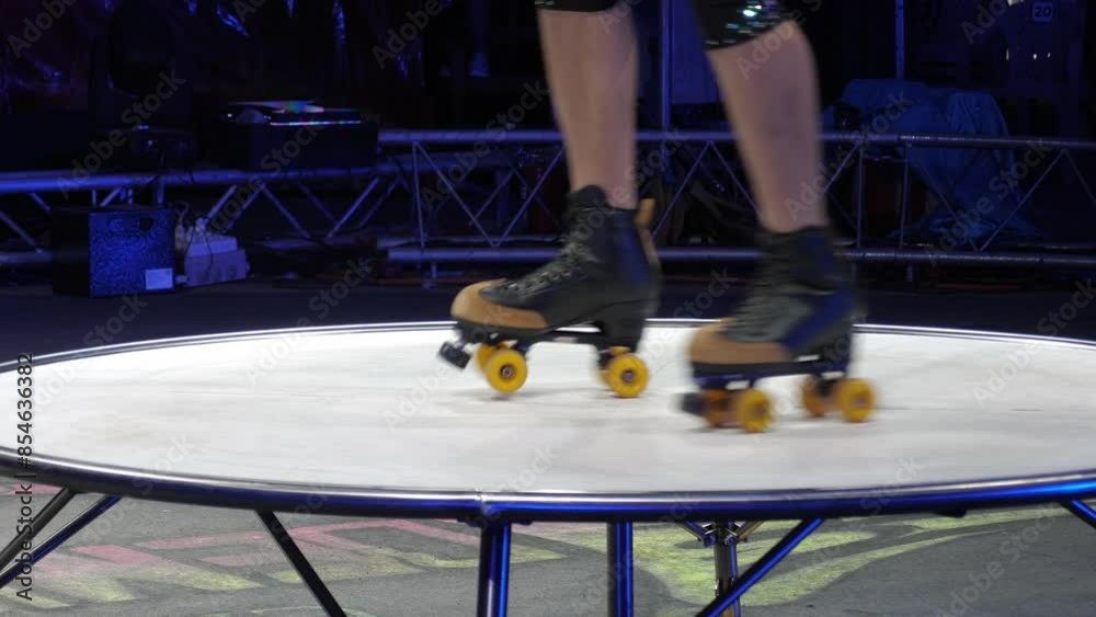 Close-up of a couple of acrobats on roller skates performing in a ...