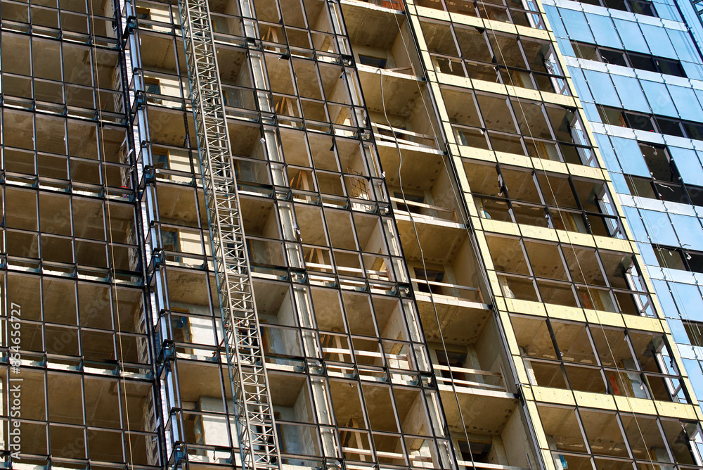 Installation of glass facade, warming exterior walls. Glass panel ...