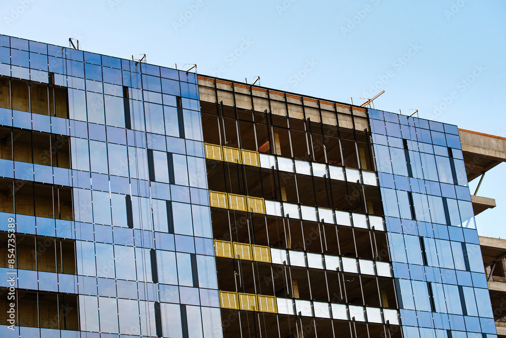 Installation of glass facade, warming exterior walls. Glass panel ...