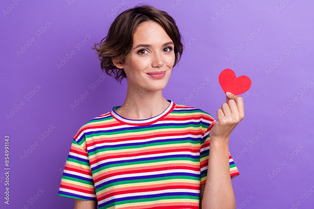 Portrait of cute friendly girl hand hold small red paper heart symbol ...