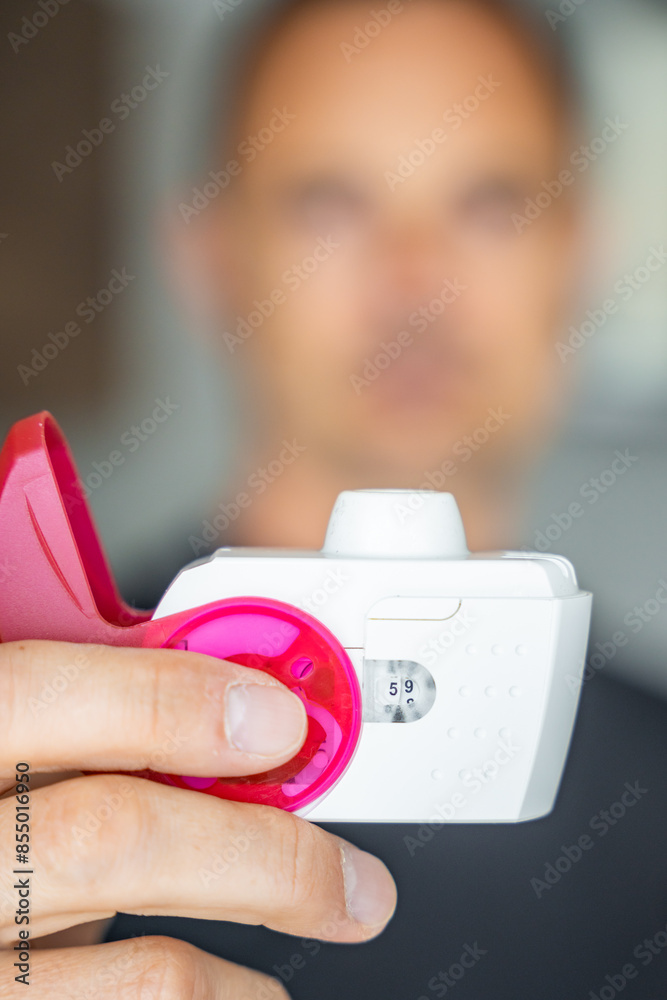 Close up view of man using medicine dry powder inhaler for treatment ...