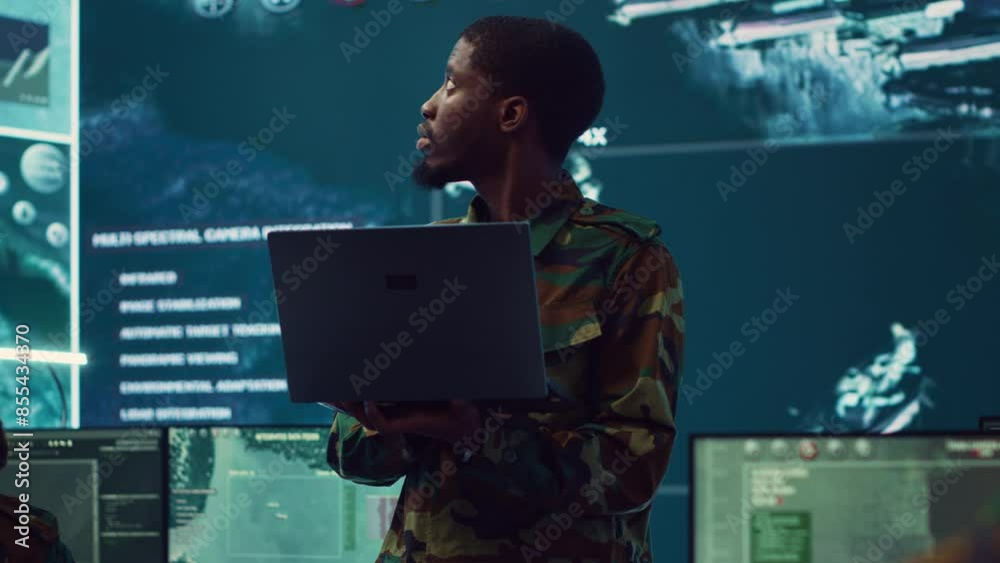 Infantry unit leader examines big data on a screen in military ...