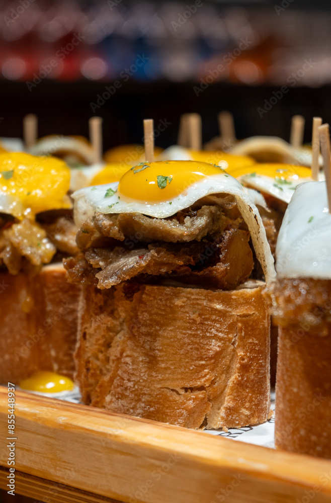 Typical snack of Basque Country, pinchos or pinxtos skewers with small ...