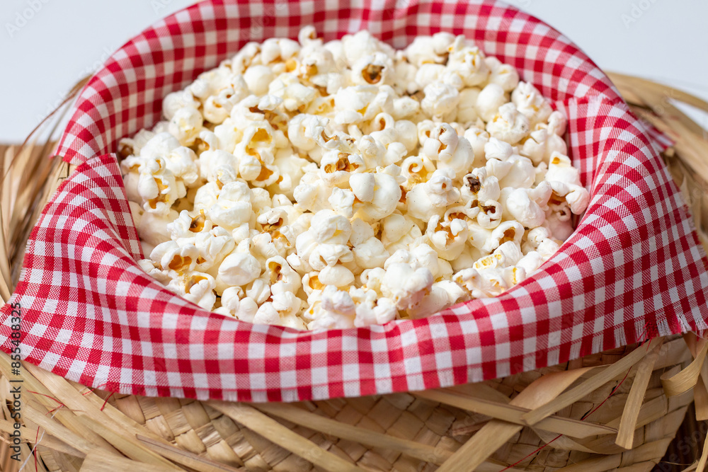 Straw hat with red and white checkered fabric and popcorn inside ...