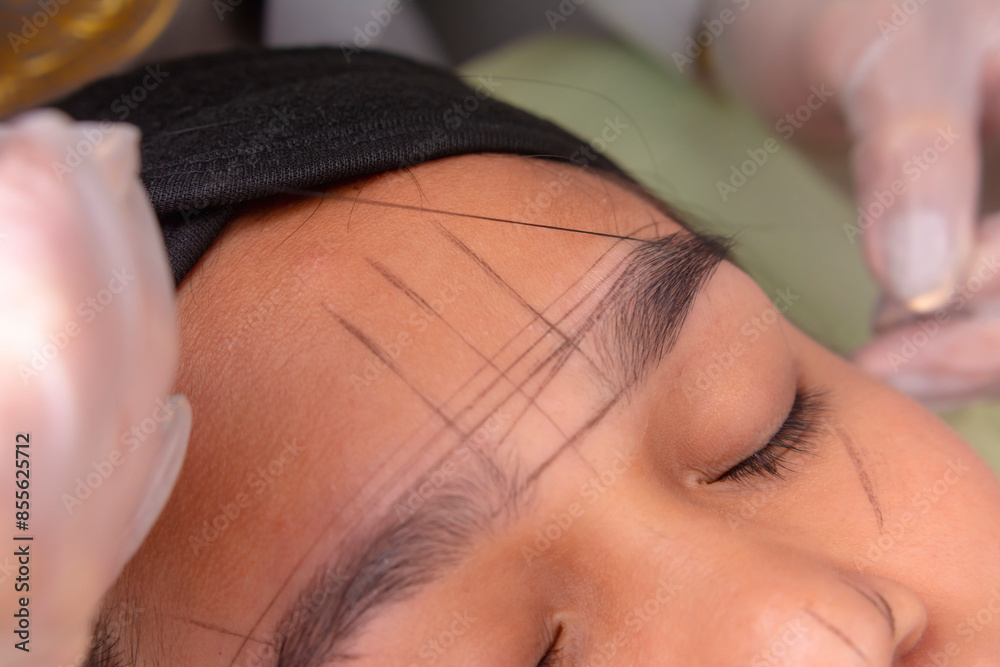 Using pre-inked mapping string to make guide lines around the eyebrows ...
