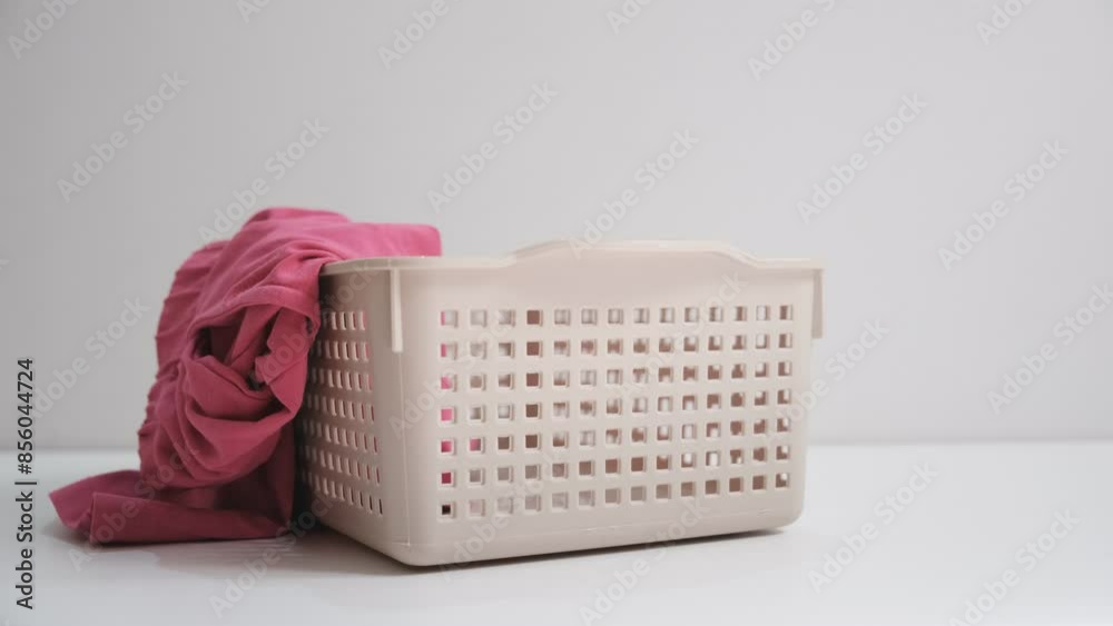 Dirty clothes falling to laundry basket close up. Simple living Stock ...