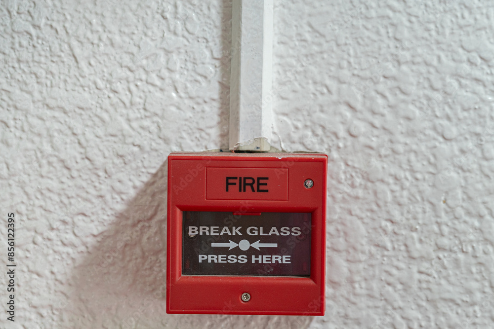 Fire alarm device that installed on building wall, press the button to ...