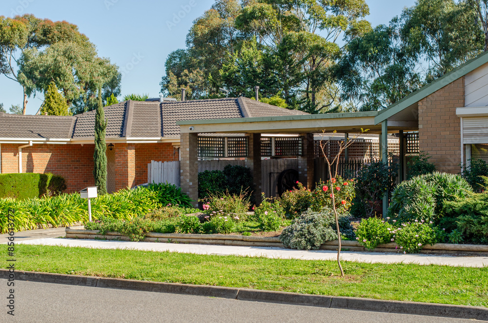 Nature strips with grass, front yard garden and the car port of a ...