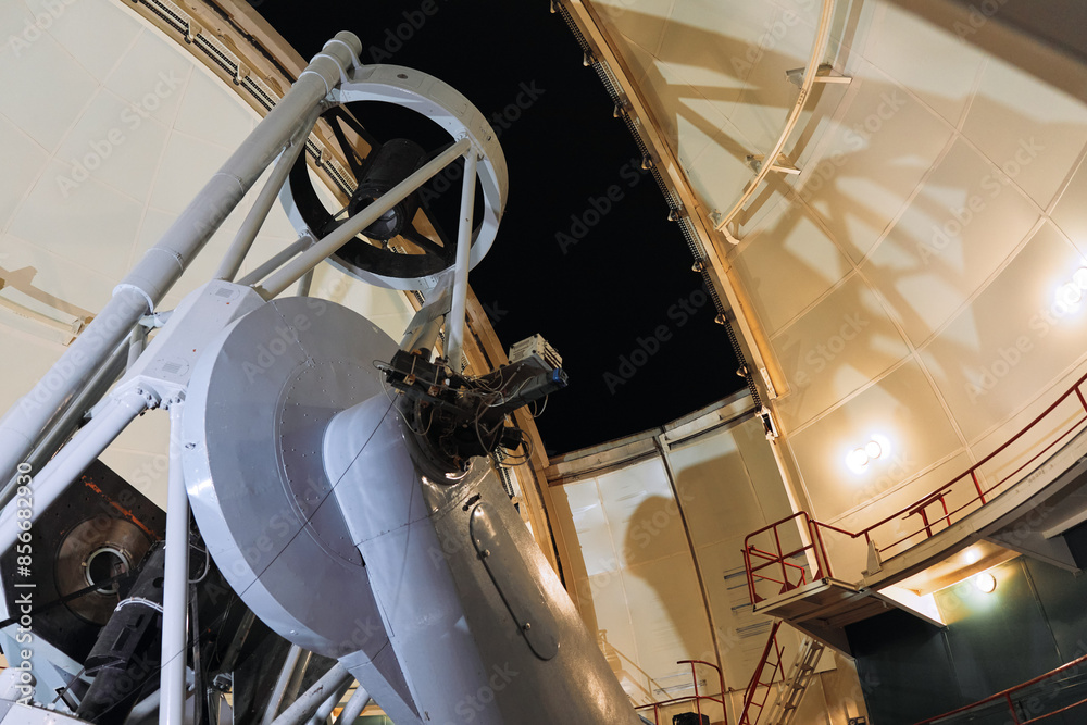 telescope in observatory with ladders on both sides for easy access to ...