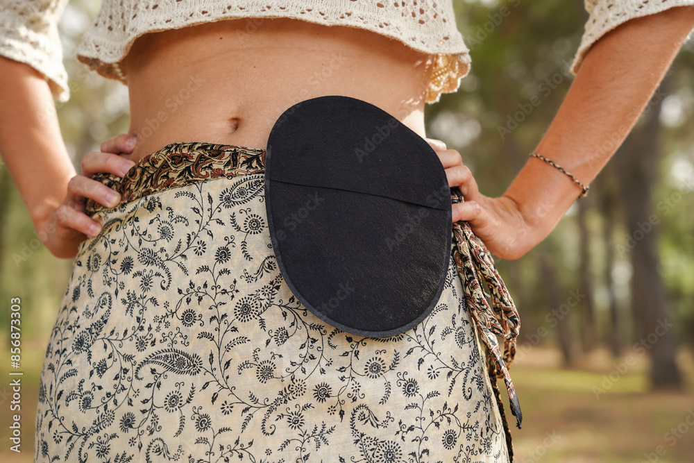 Front view of colostomy bag in black color attached to a young patient ...