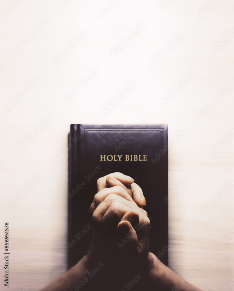 Christian background with hands together on the holy Bible, meditating ...