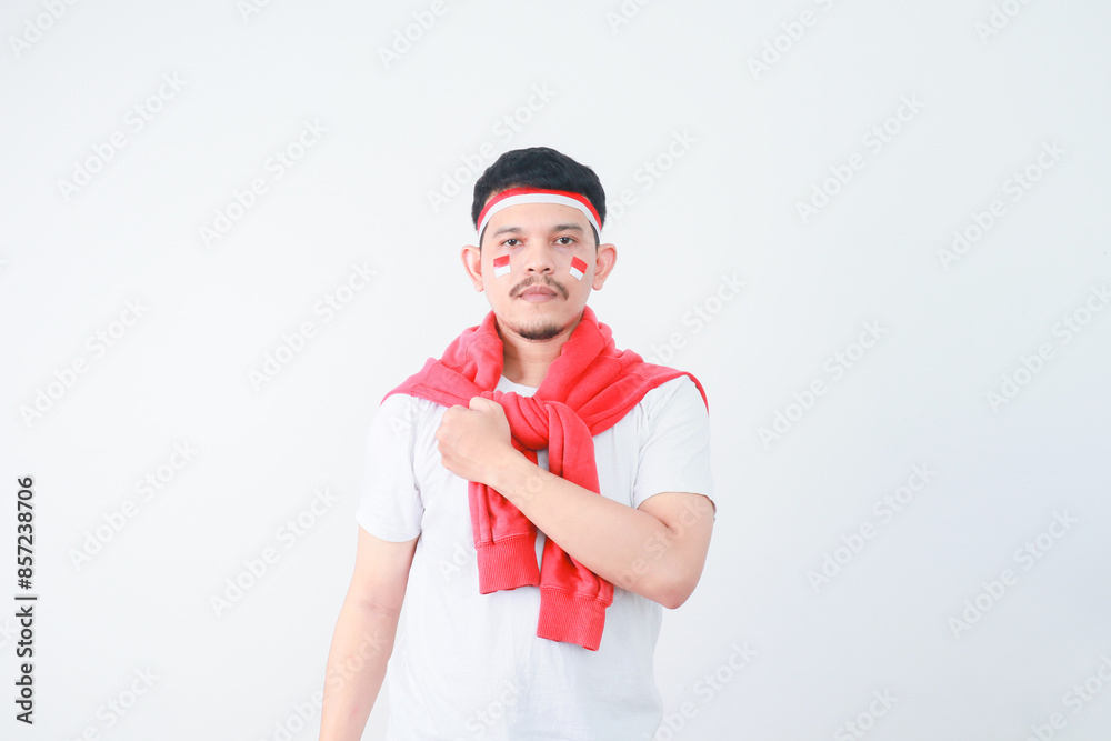 Smiling happy young Asian man giving salute gesture with hands on his ...