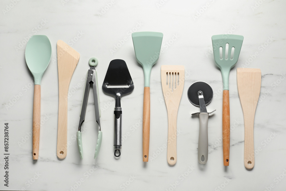 Poster Different spatulas and other kitchen utensils on white marble ...