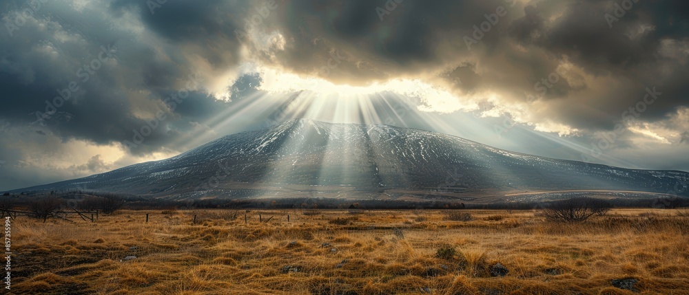 Overcast sky with sun rays breaking through and illuminating a city ...