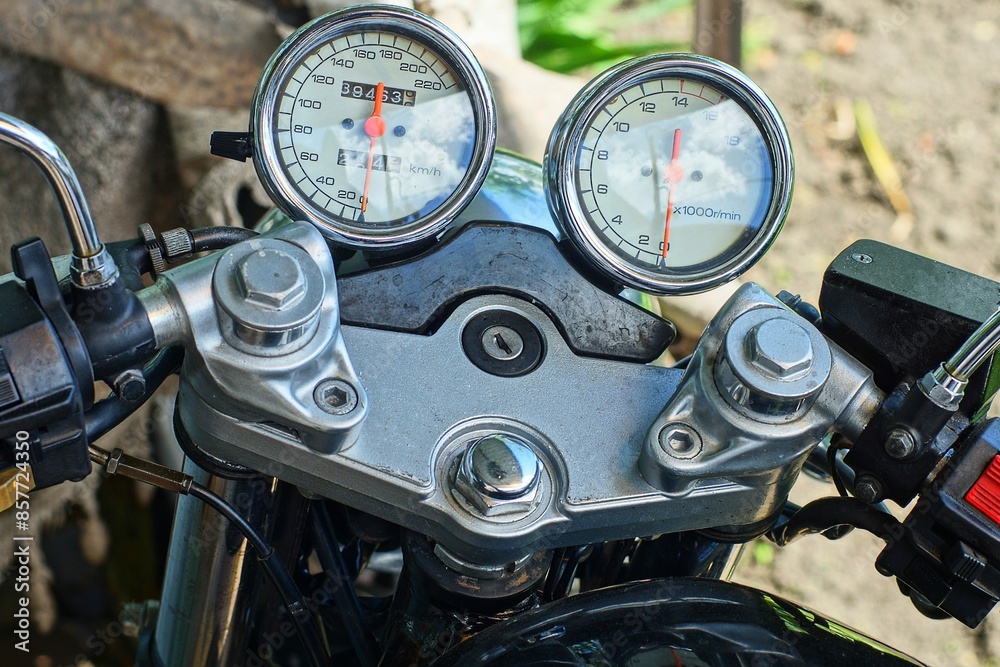 round glass speedometer and tachometer with a white scale and a red ...