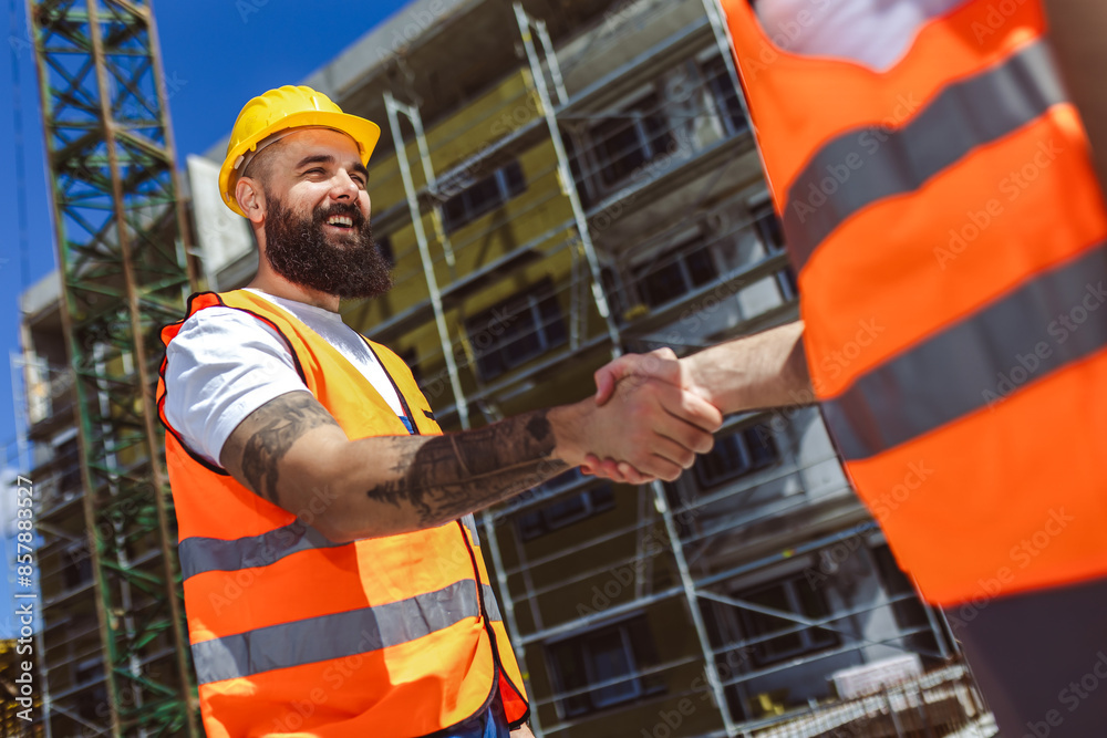 Contractor. construction worker team hands shaking after plan project ...