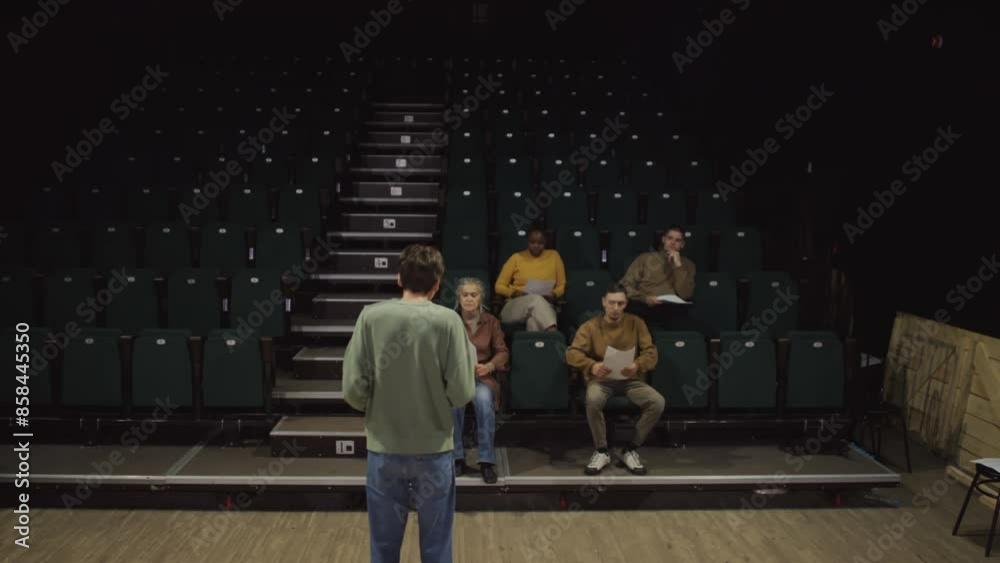 Professional actor going from stage to colleagues sitting in audience ...