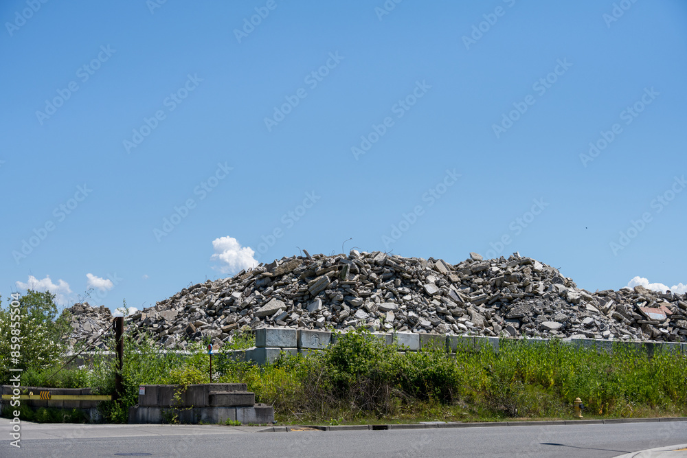 Large pile of broken up concrete and rebar held back with retaining ...