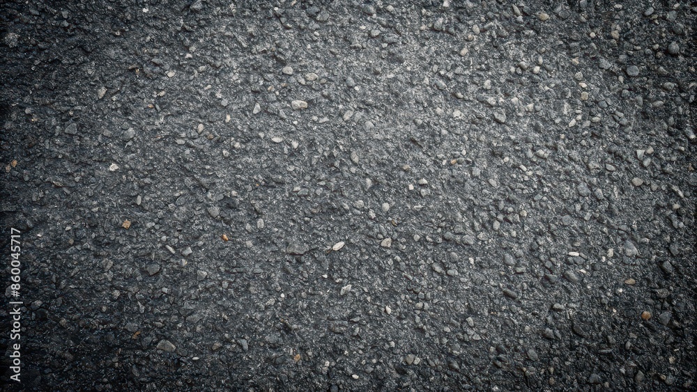 Dark gray rough surface resembling concrete or asphalt road with grainy ...