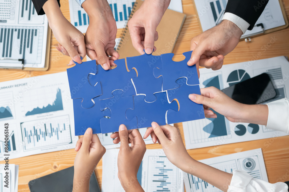 Multiethnic business people holding jigsaw pieces and merge them ...