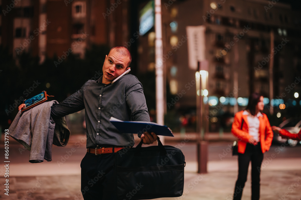 Young business person multitasking and communicating outside an office ...