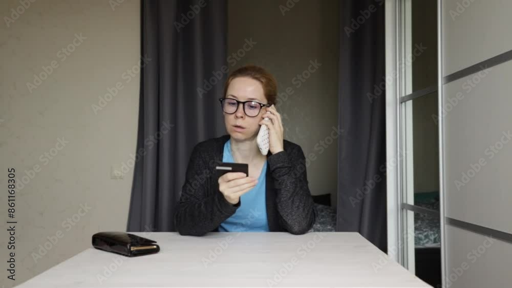 Victim of phone scammers, shocked woman with smartphone and credit card ...