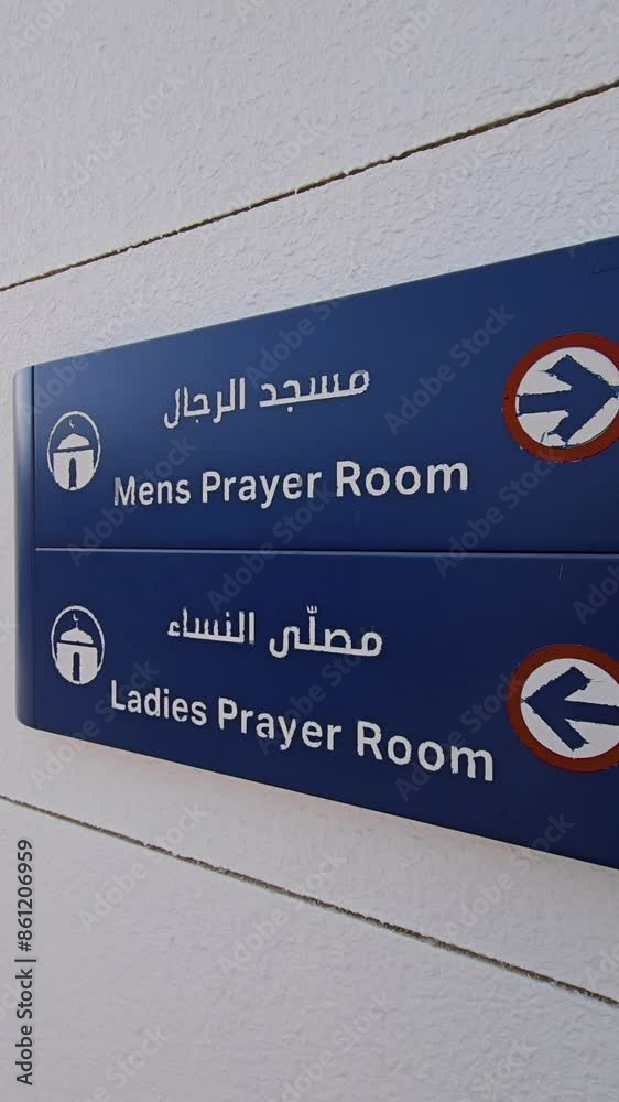 Male and female prayer room signs displayed outside the rest area of a ...