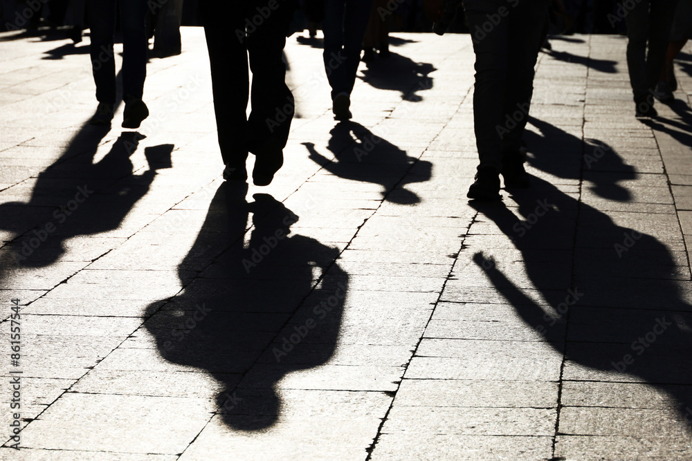 Black silhouettes and shadows of people on the street. Crowd walking ...