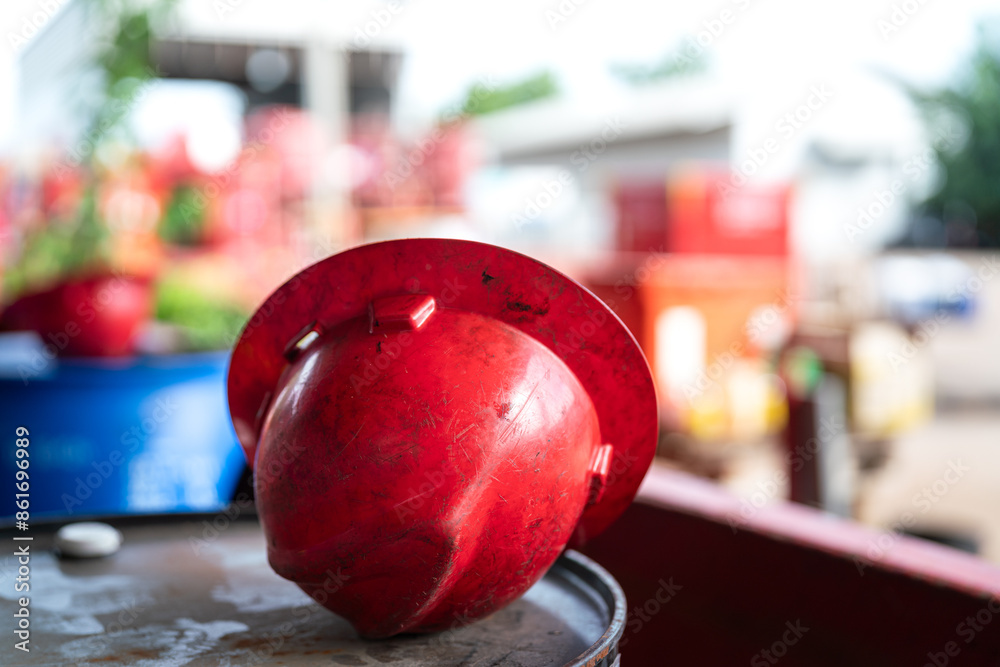 A red safety helmet for industrial worker is placed on the chemical ...