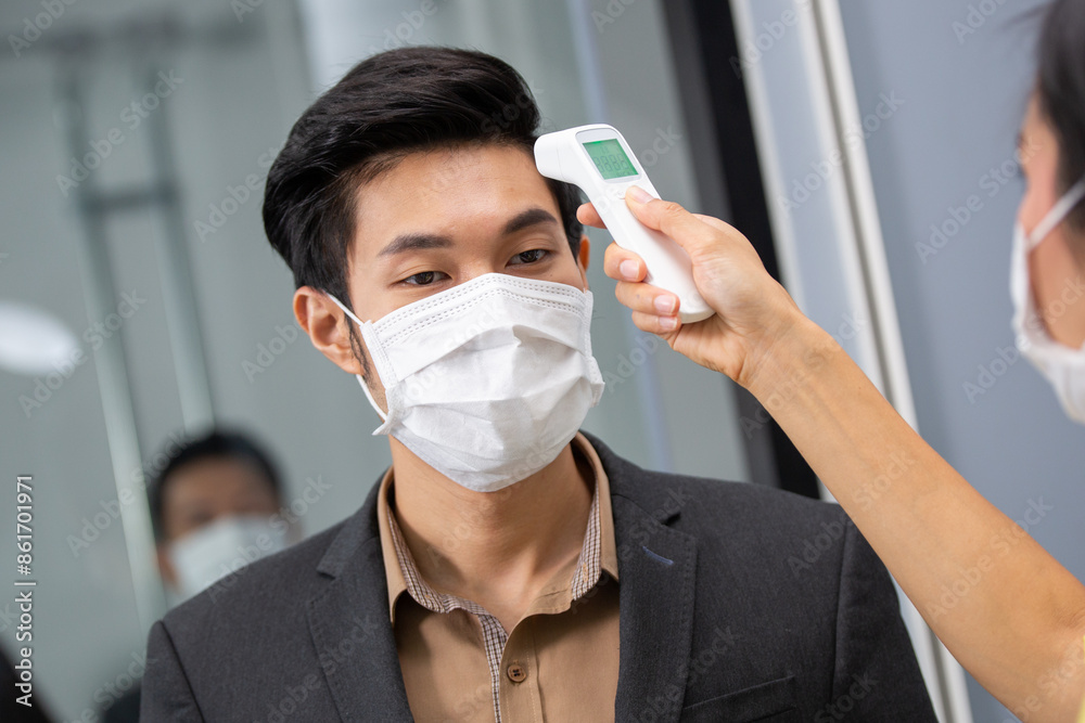 Asian employee woman using infrared thermometer check fever temperature ...