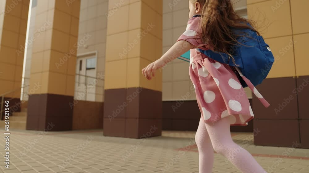 Cheerful smiling little girl running to school lesson elementary ...