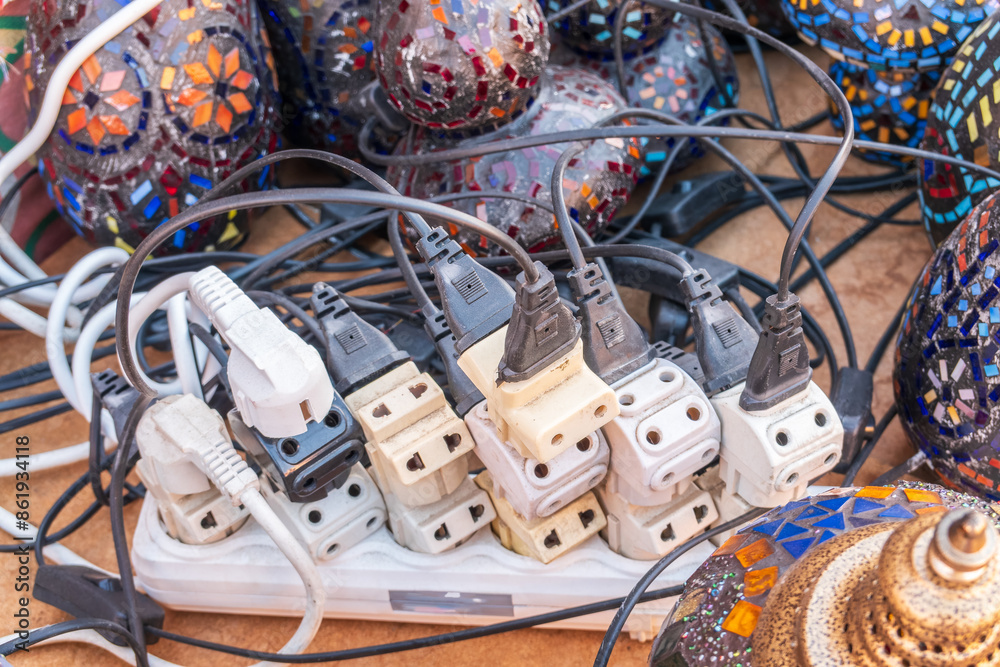 Old and damaged electric adapter power plug has many appliances are ...