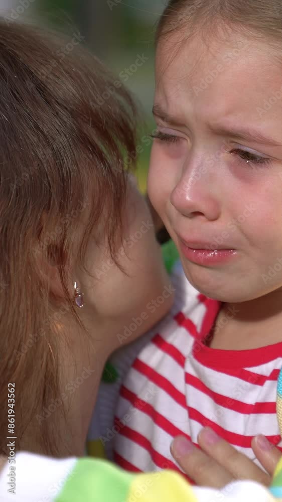 little child cries, tears child face, mother calms capricious kid girl ...