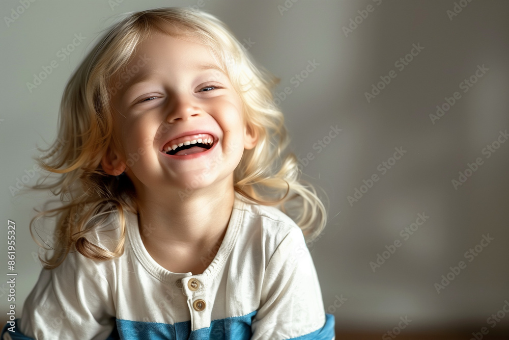 The image shows five children smiling brightly at the camera. The group ...