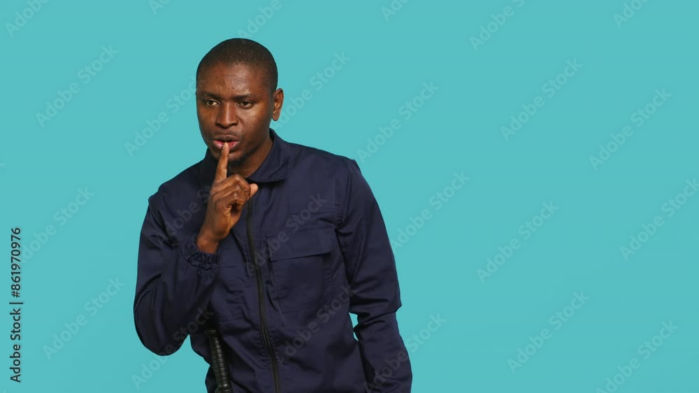 Security guard doing shush sign gesturing with finger, preventing ...