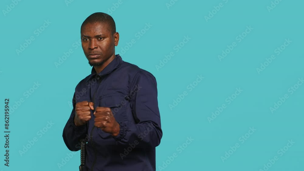 Security guard standing in fighting stance, prepared to deal with ...