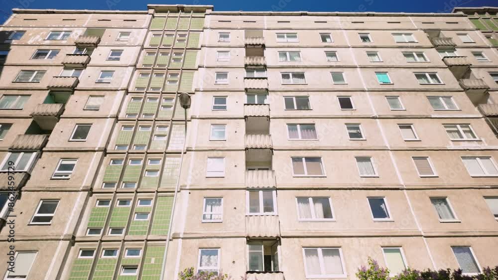 Footage shows a low angle view of a high-rise concrete Khrushchevka ...
