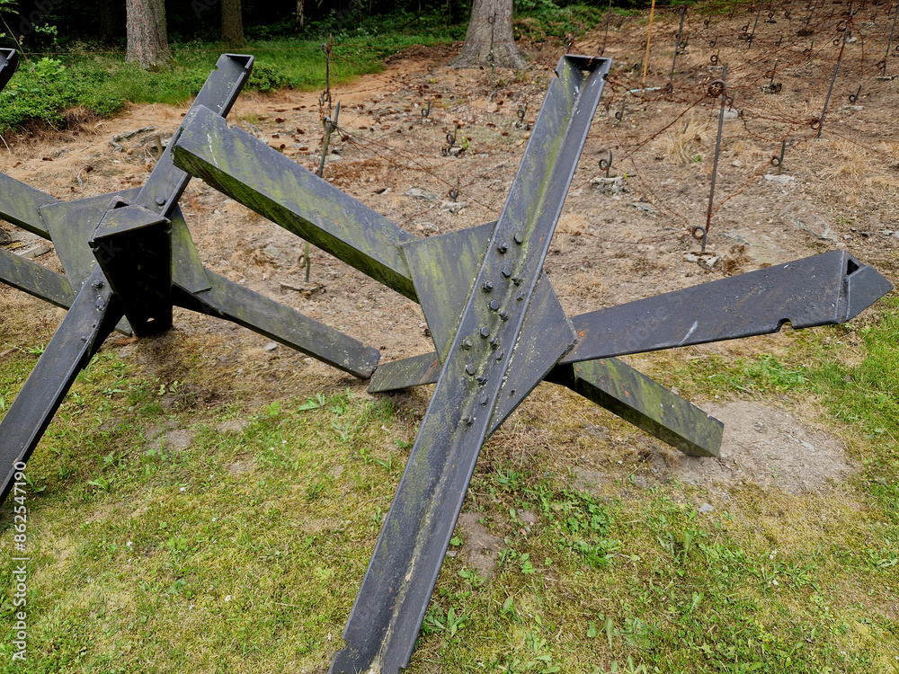 gun position behind wire barriers in trench. anti-tank measures made of ...