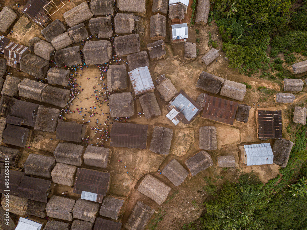Aerial view of traditional village with thatched roofs and greenery in ...