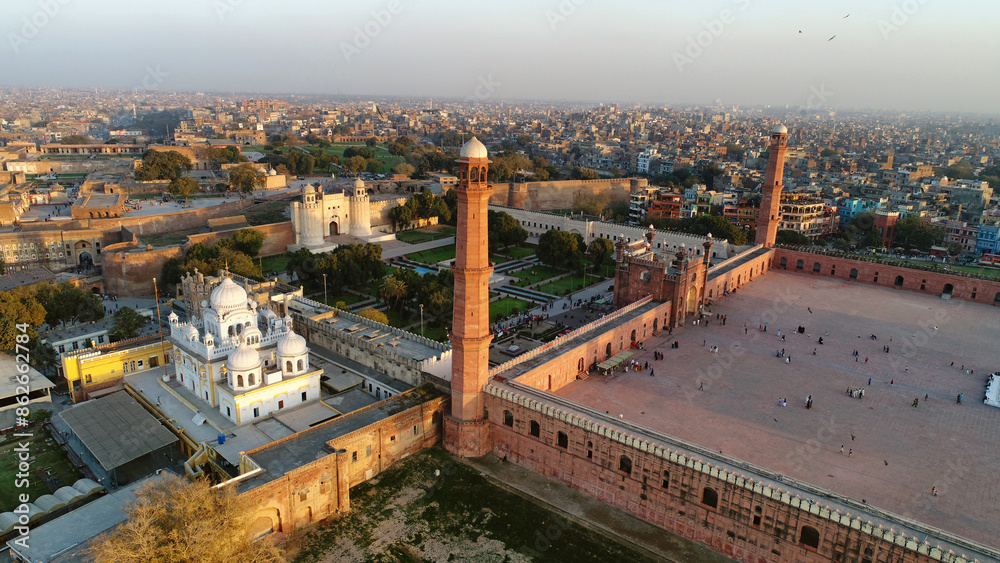 Aerial view of historic mosque, fort, and minaret in bustling walled ...