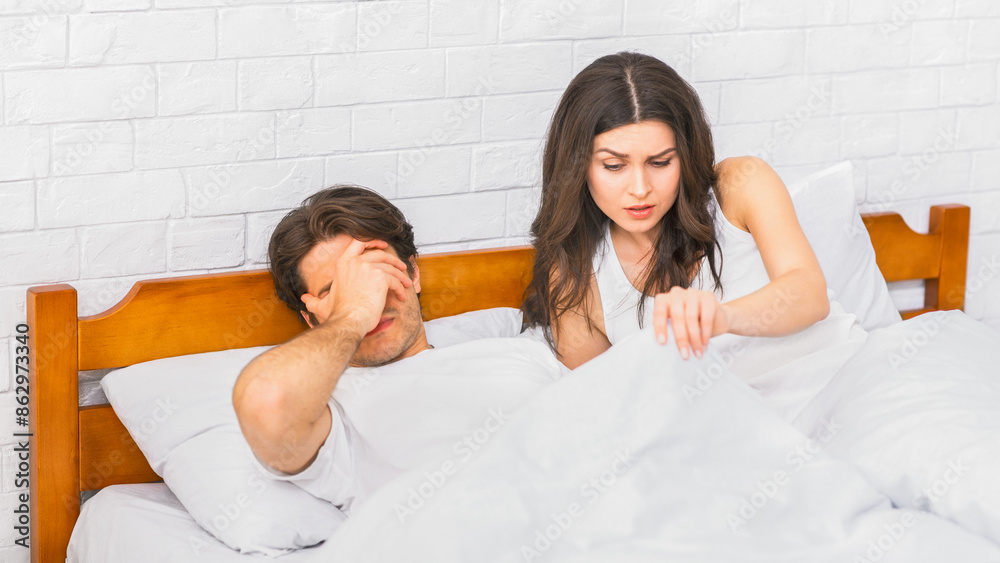 A woman sits up in bed, looking shocked and disgusted as she discovers ...