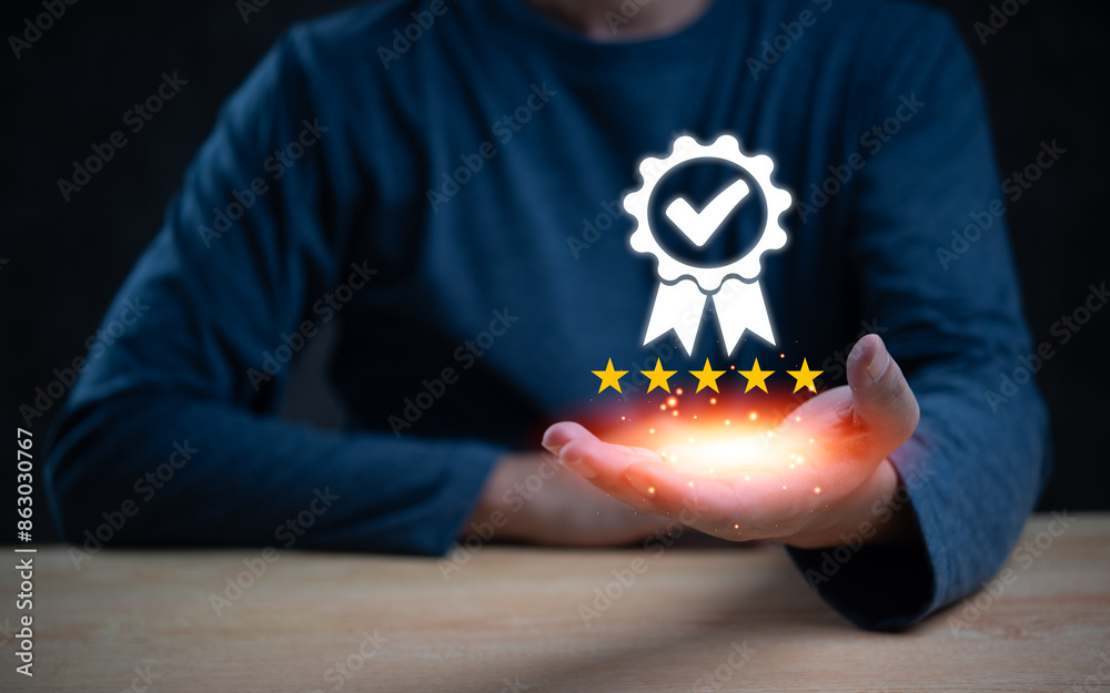 Hand holding a glowing five-star quality assurance badge with a ...