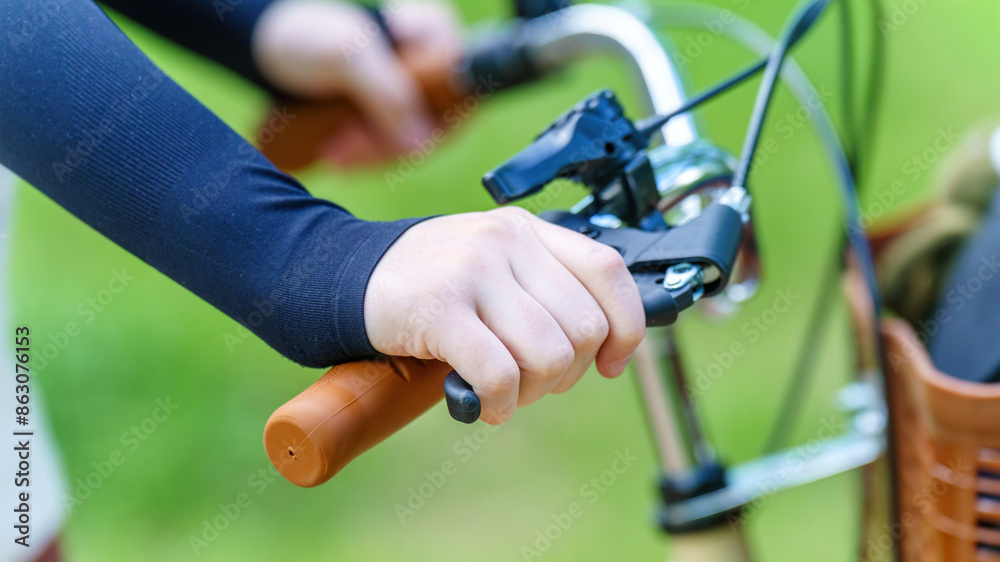 child hand pressing the hand brake on a bicycle, learning bike safety ...